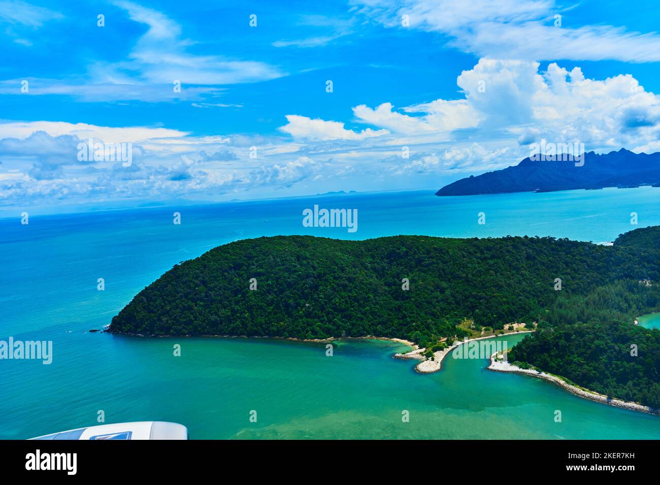 View of a green tropical island in the ocean from the airplane window ...