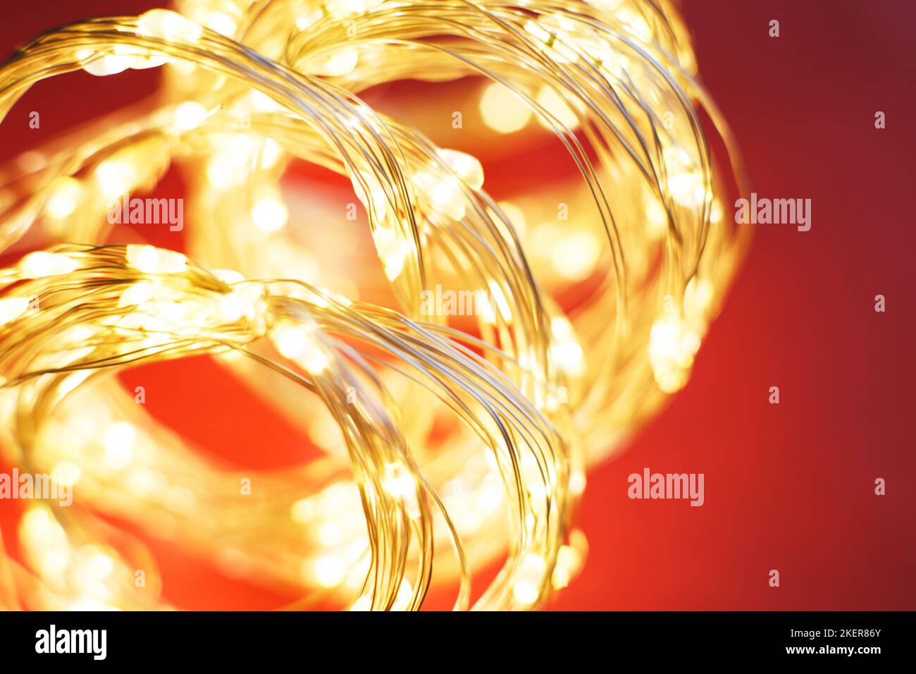 christmas beautifull shiny gold garland on a red background. sparkle ...