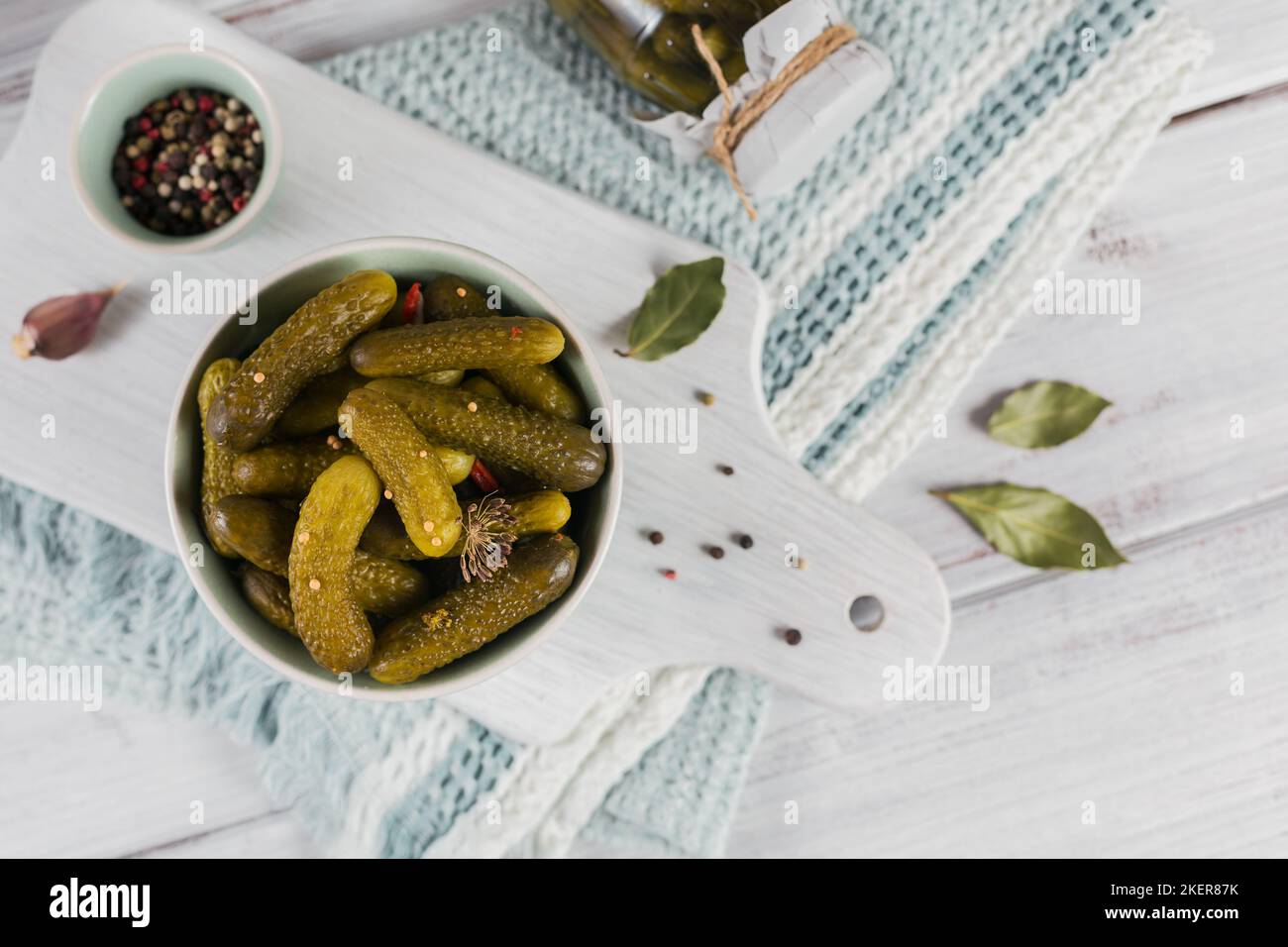 Plate of gherkins, pickled cucumbers on a white rustic wooden ...