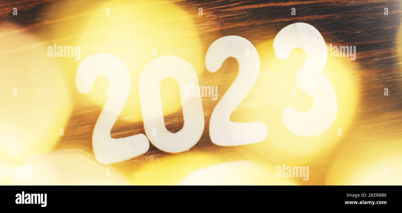 wooden number 2023 on christmas beautifull shiny gold background ...