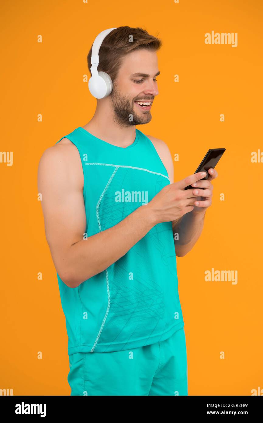 Mobile device is your workout companion. Happy sportsman hold mobile ...