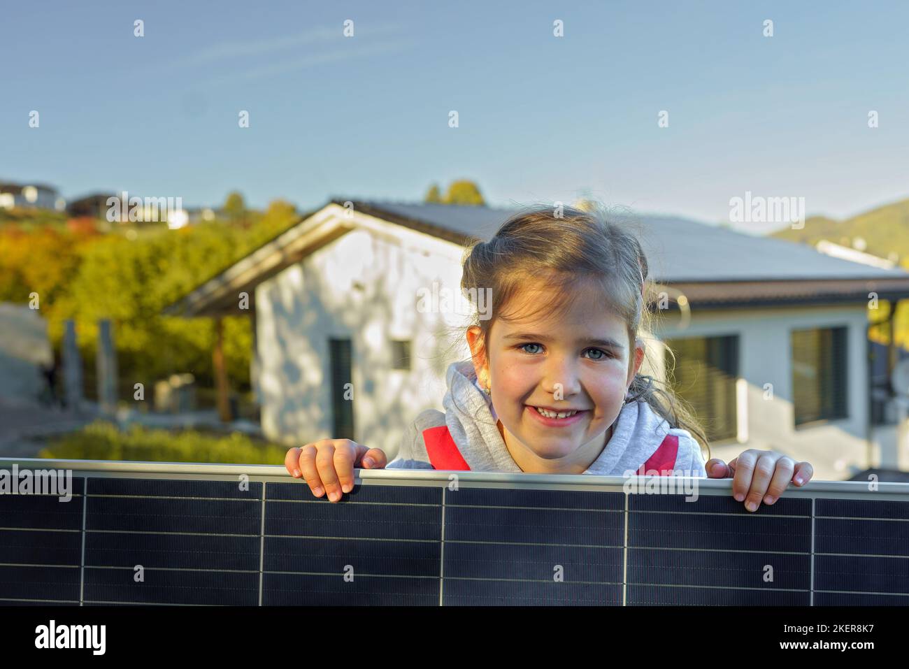 Little girl holding photovoltaics solar panel. Alternative energy ...