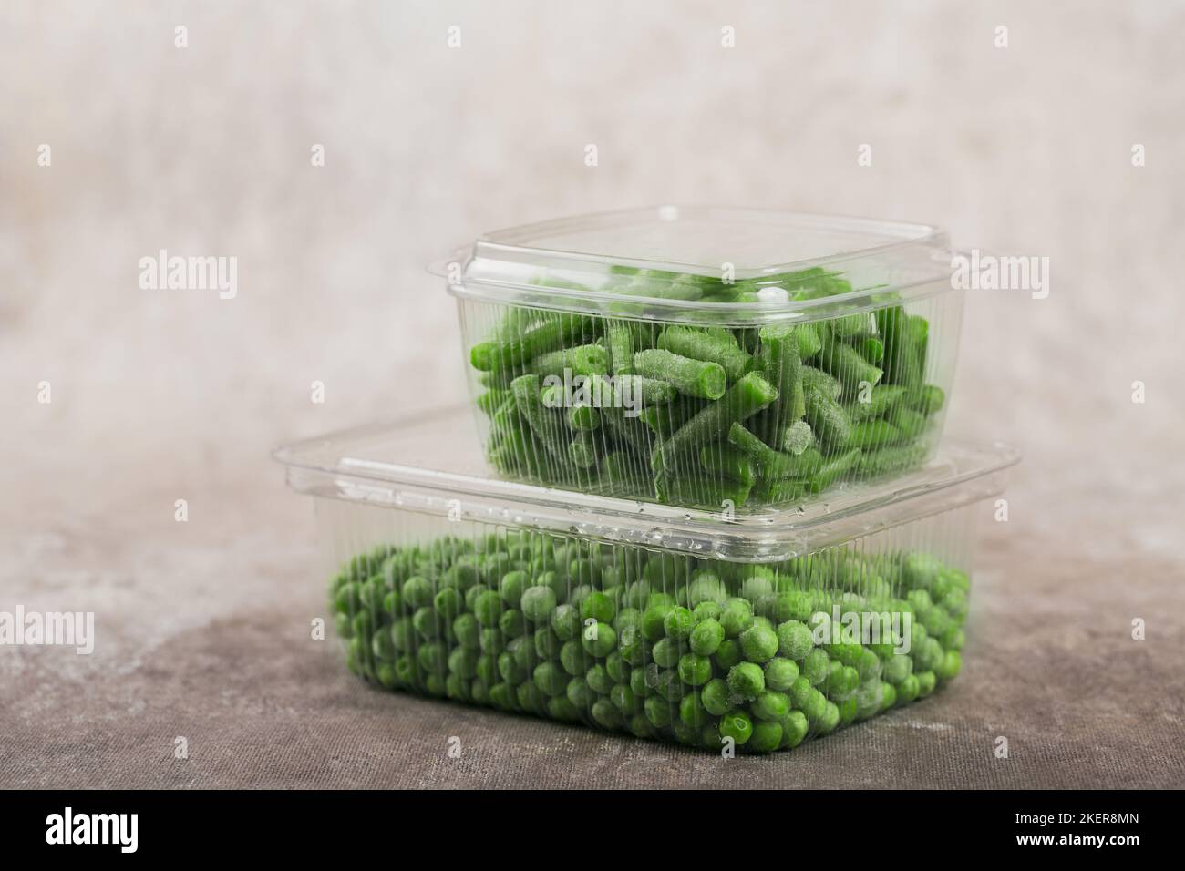 Plastic container with different organic deep frozen vegetables on a ...