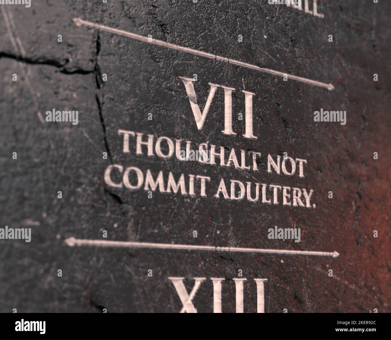 A view of the seventh commandment etched into a cracked stone tablet on ...