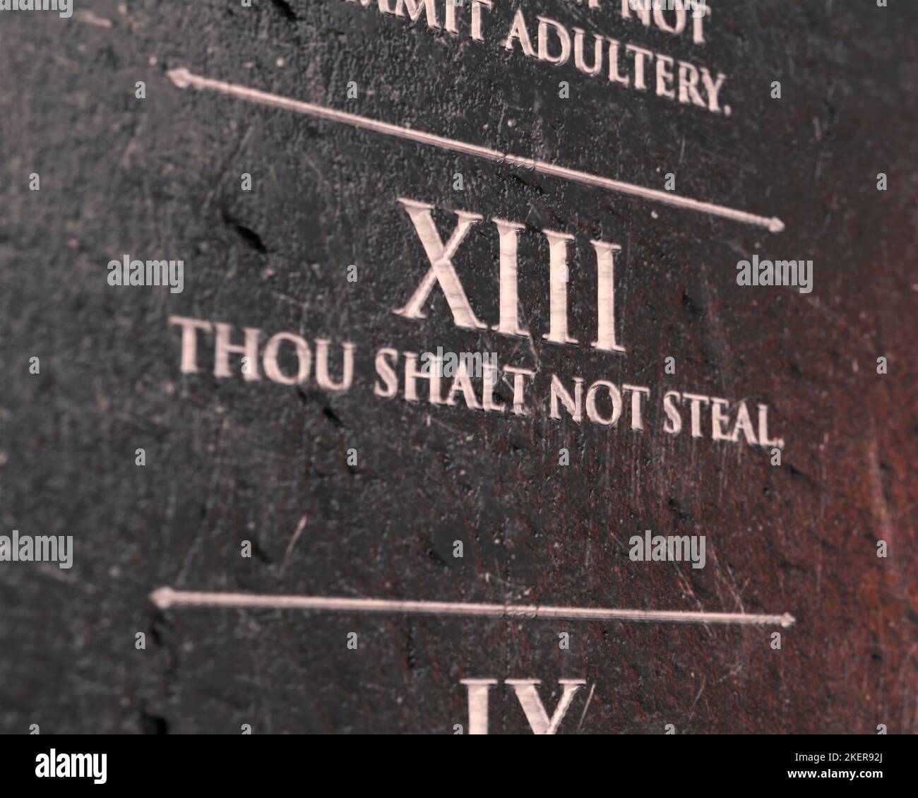 A view of the eight commandment etched into a cracked stone tablet on ...