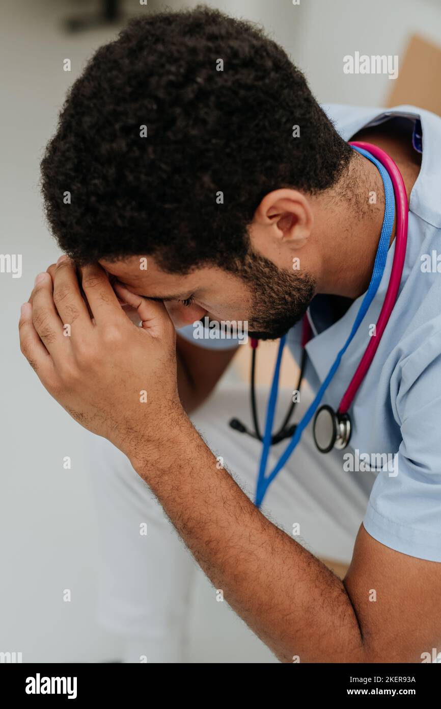 High angle view of tired doctor, sitting at hospital corridor Stock ...