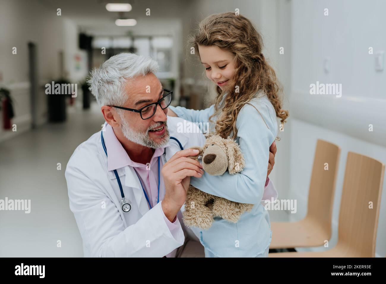 Doctor playing with his little patient at pediatrics Stock Photo - Alamy