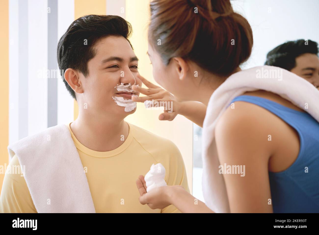 Young woman applying shaving cream on face of her husband Stock Photo - Alamy