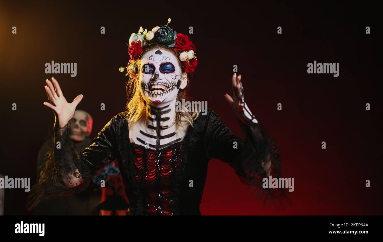 Horror lady of death screaming loud dressed in costume with skull body ...