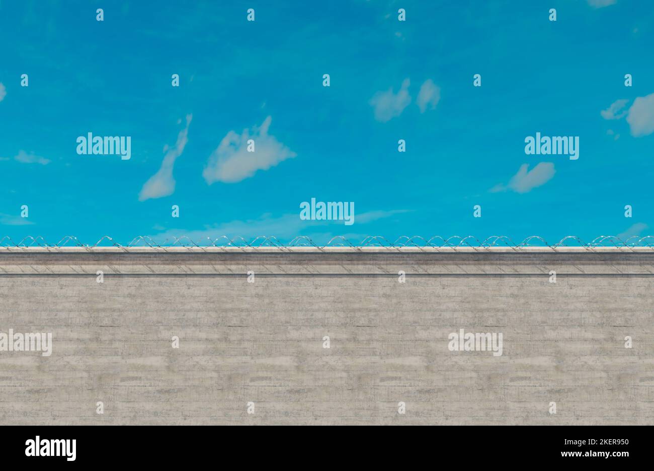 A massively high concrete security boundary wall topped with barbed ...