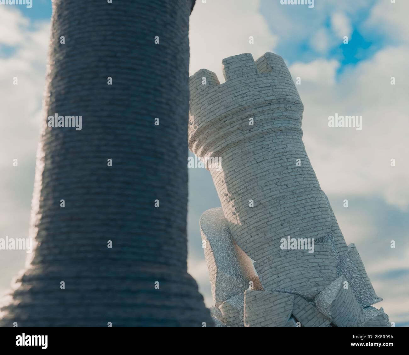A black chess castle opposing a crumbling white castle on a chess board ...