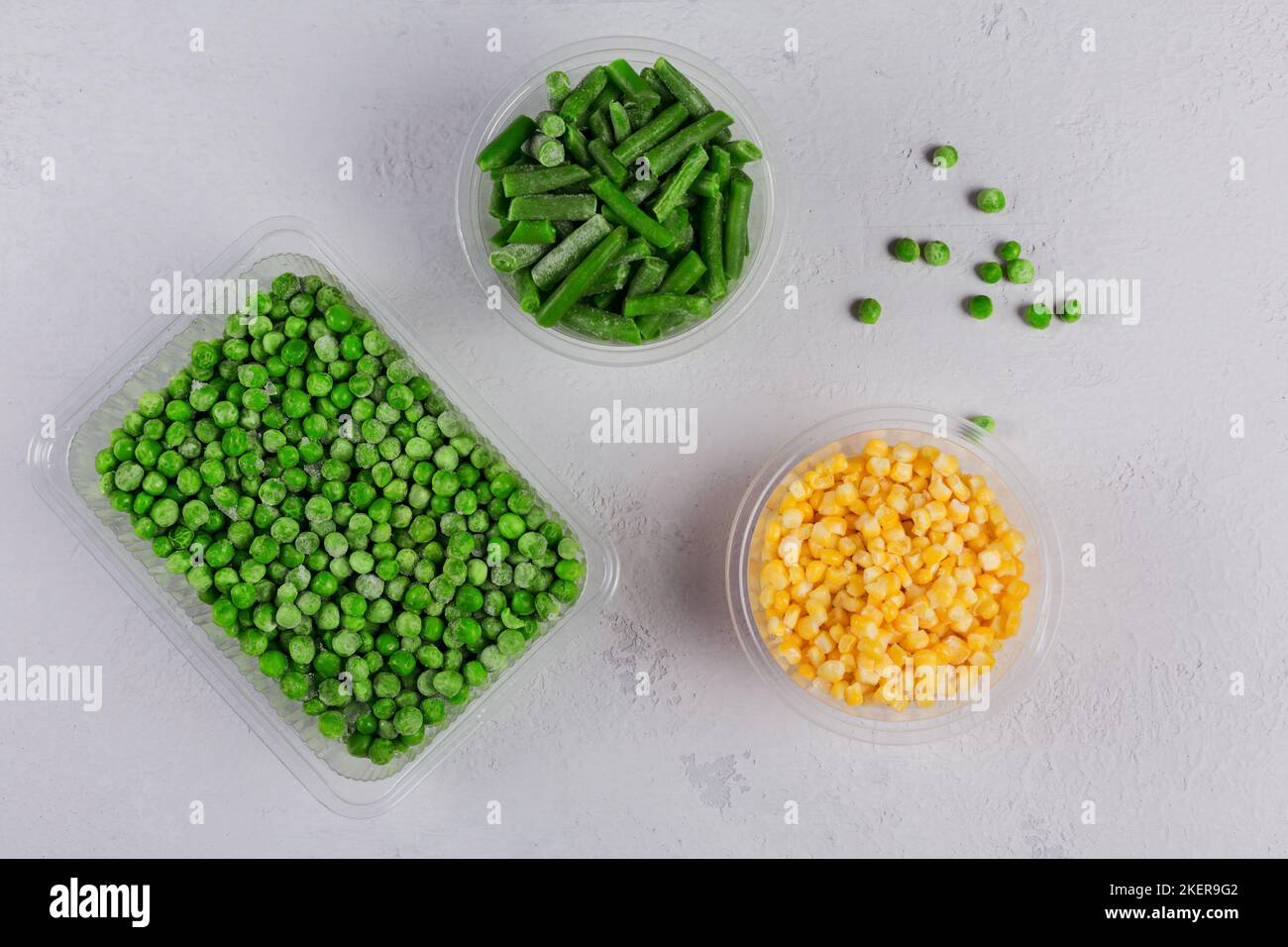 Plastic container with different organic deep frozen vegetables on a ...
