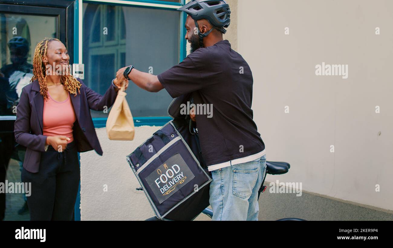 Delivery service employee delivering lunch meal order to client, man ...