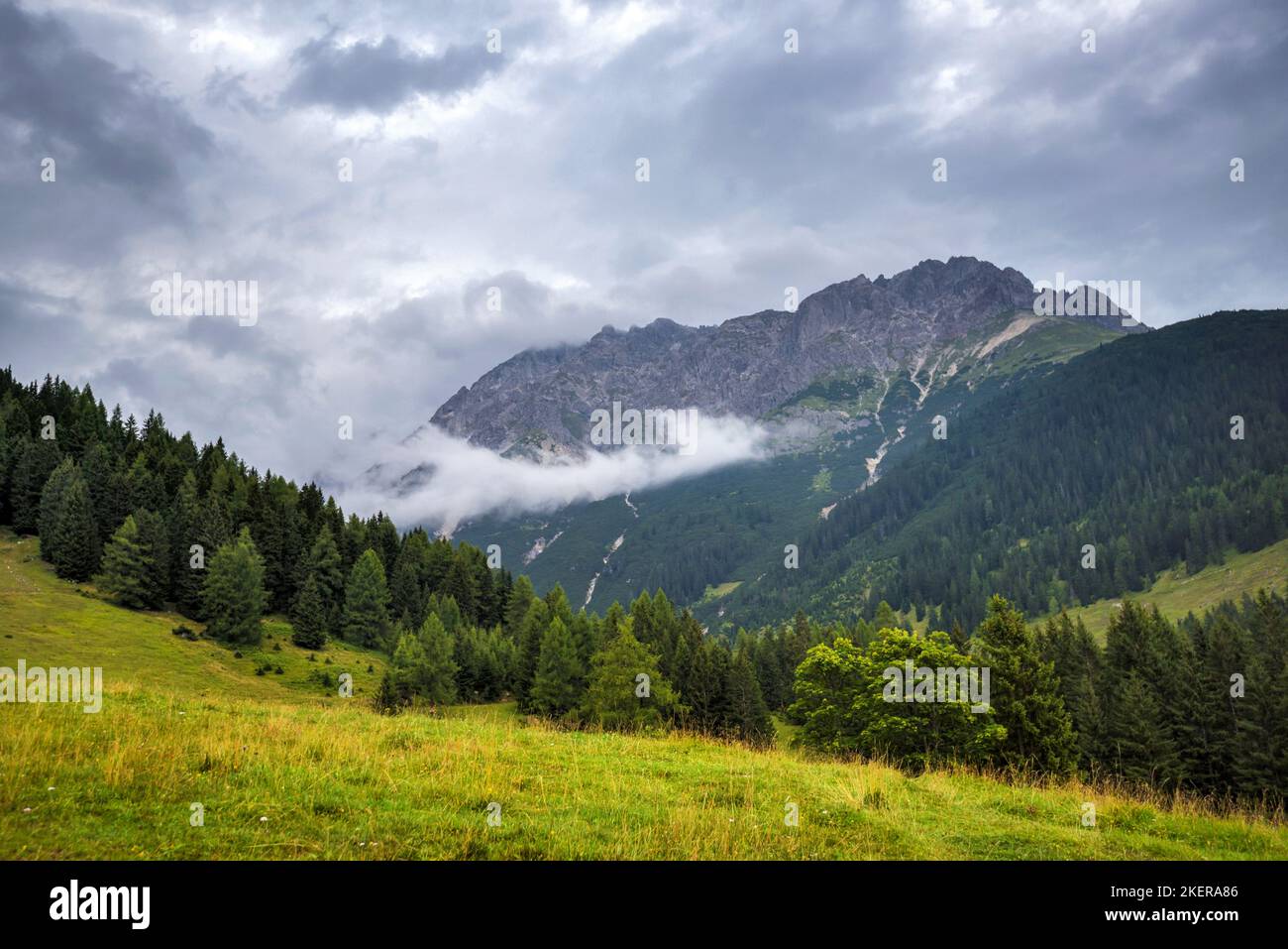 Summer mountain landscape with thunderstorm clouds. Location place Alps ...