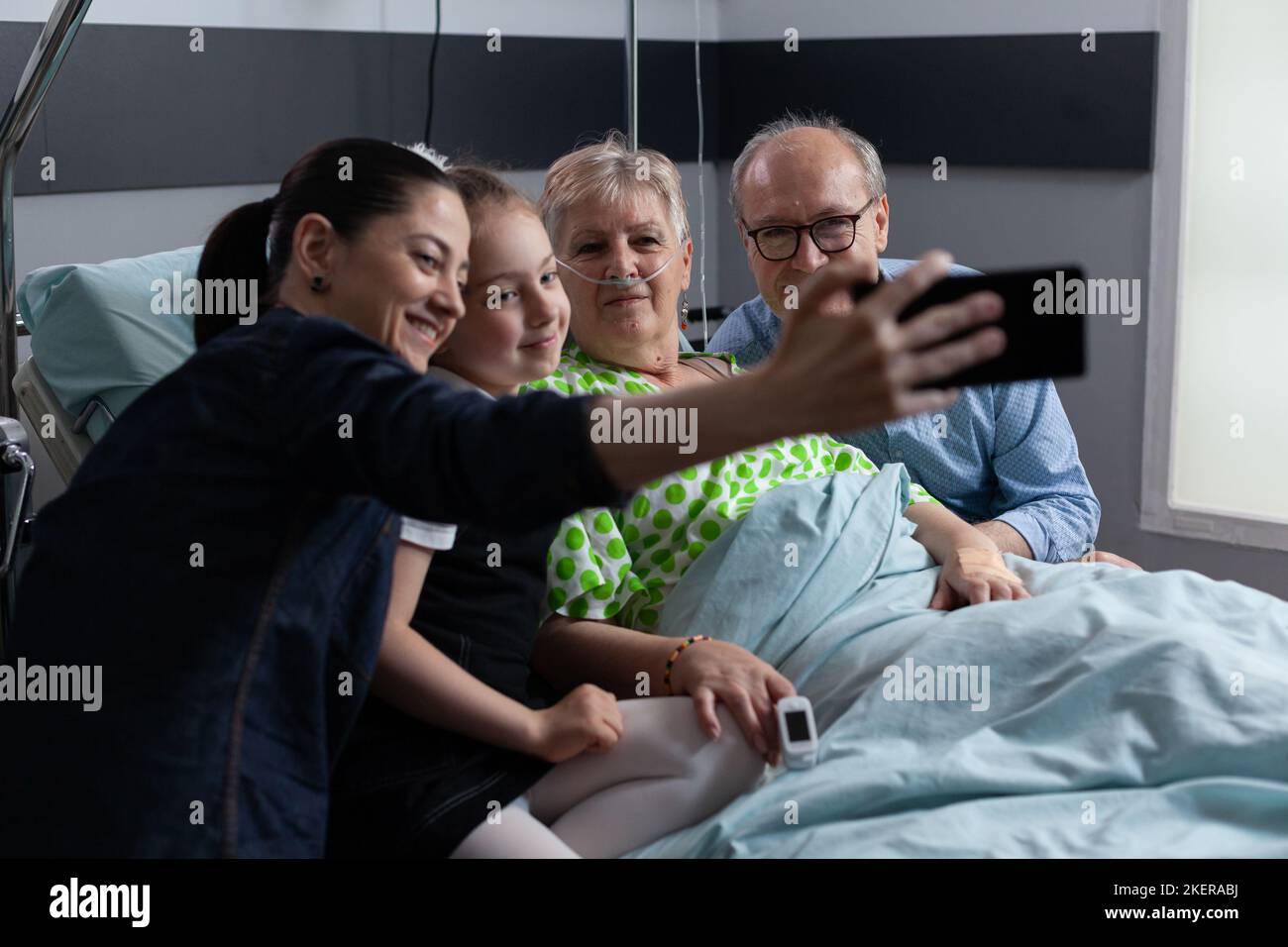 Elderly patient smiling for selfie alongside husband, daughter ...