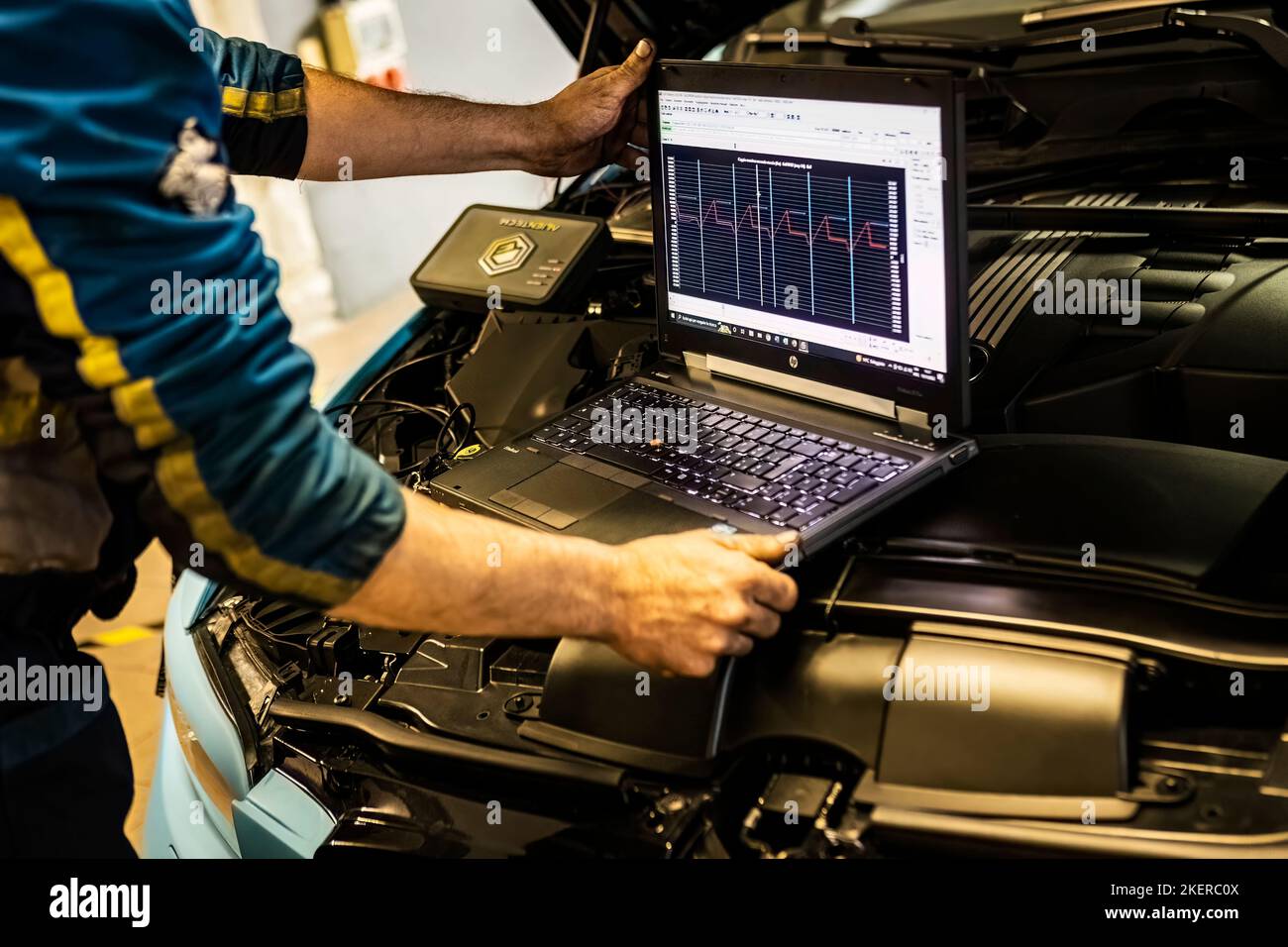 Milan, Italy 13 November 2022: Mechanic perform chip tuning on tuned ...