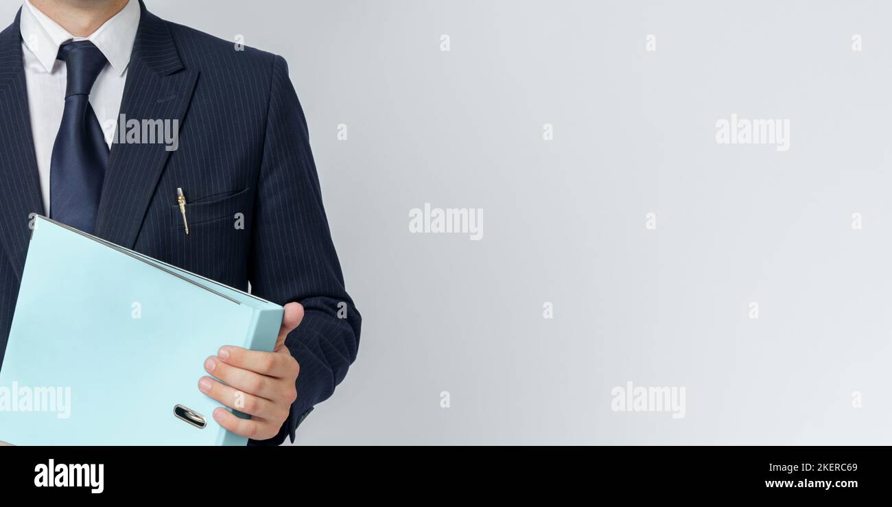 Businessman in a blue suit holds a folder in his hands on a white ...