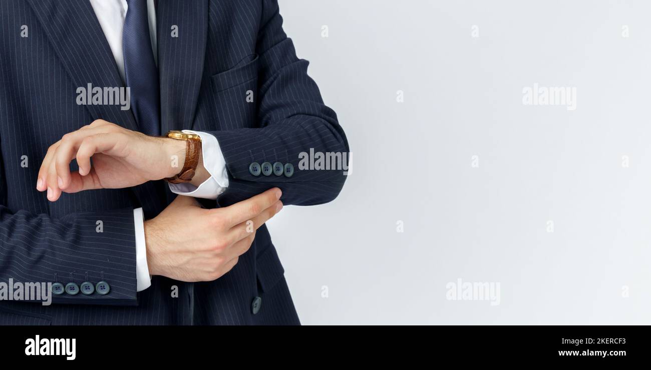Portrait of a businessman in a blue suit straightening his suit. No ...