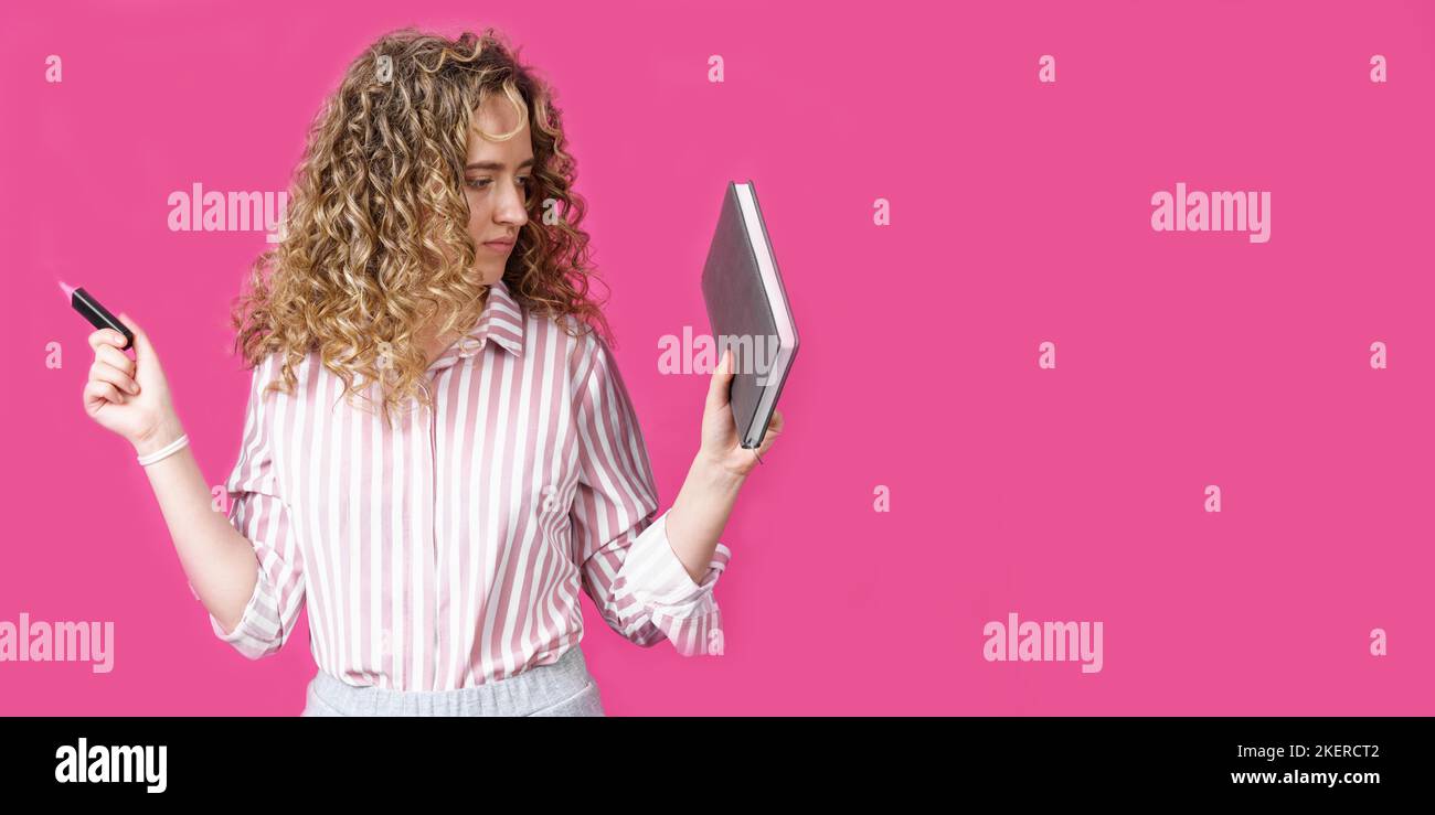 Fashionable woman in a striped shirt holding a diary and a marker ...
