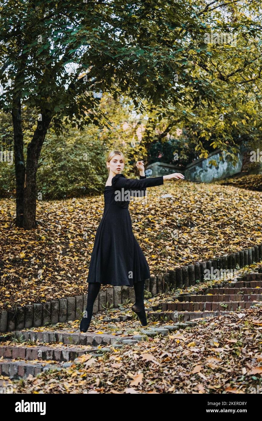 Ballerina Dancing in autumn city street, Modern Ballet Dancer in black ...