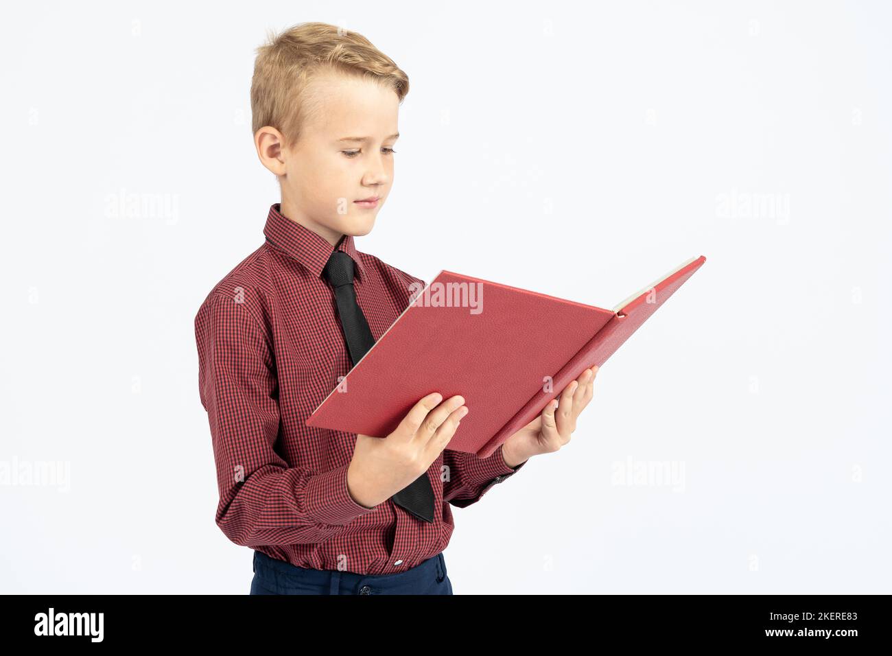 Pupil holds an open book in his hands and reads, isolated background ...