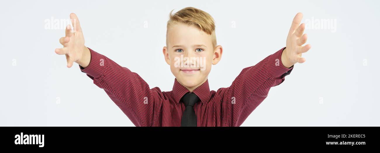 Portrait of a schoolboy with open arms who smiles. Education concept ...