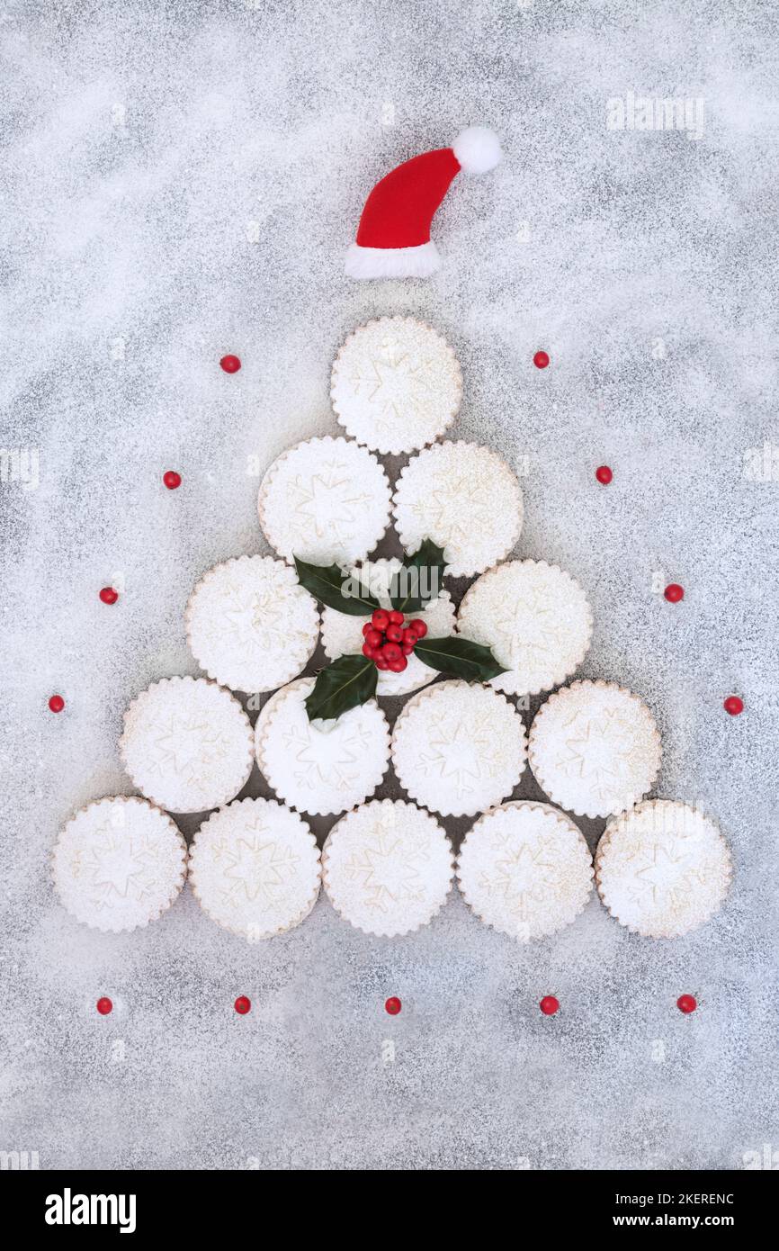 Festive fun Christmas tree mince pie tree concept shape with santa hat ...