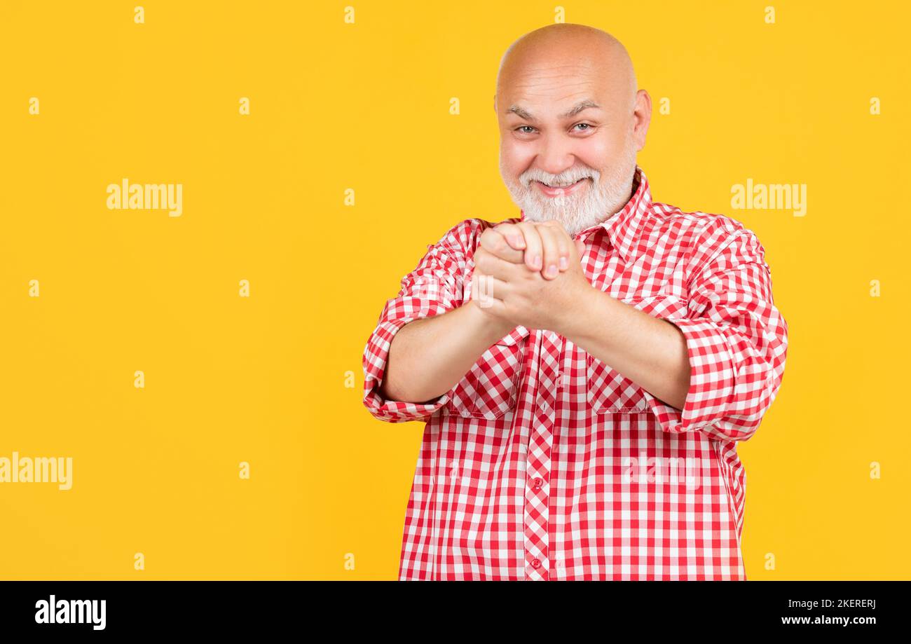 glad senior man or grandfather in checkered shirt on yellow background ...