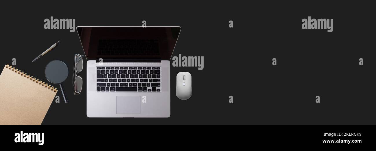 laptop computer with screen, and stationery on dark table Stock Photo ...