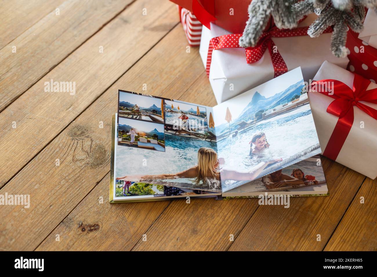 Photo book album under the Christmas tree surrounded by Christmas gifts ...