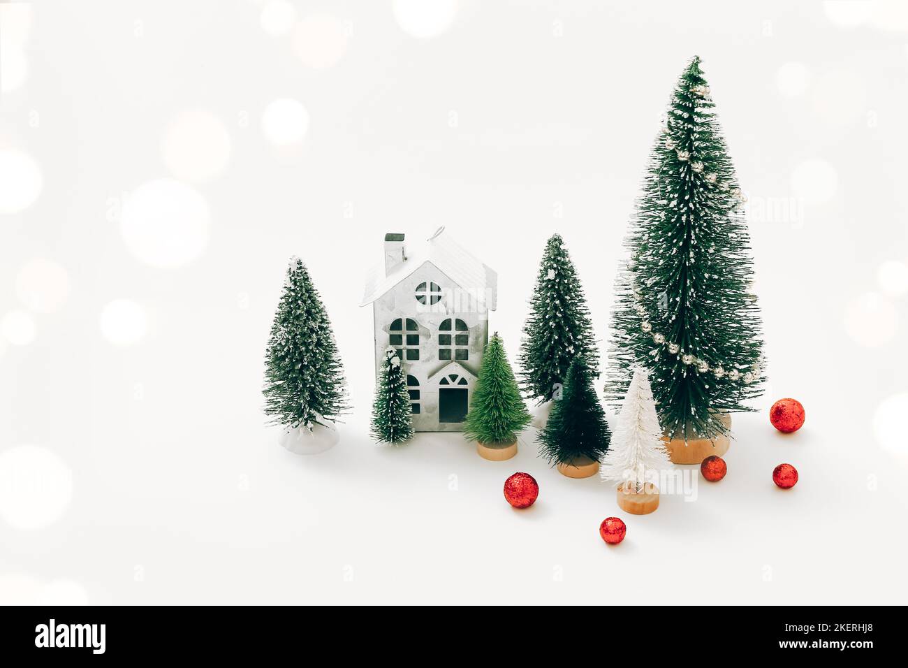Christmas decorations, holiday concept. Miniature house and fir trees ...