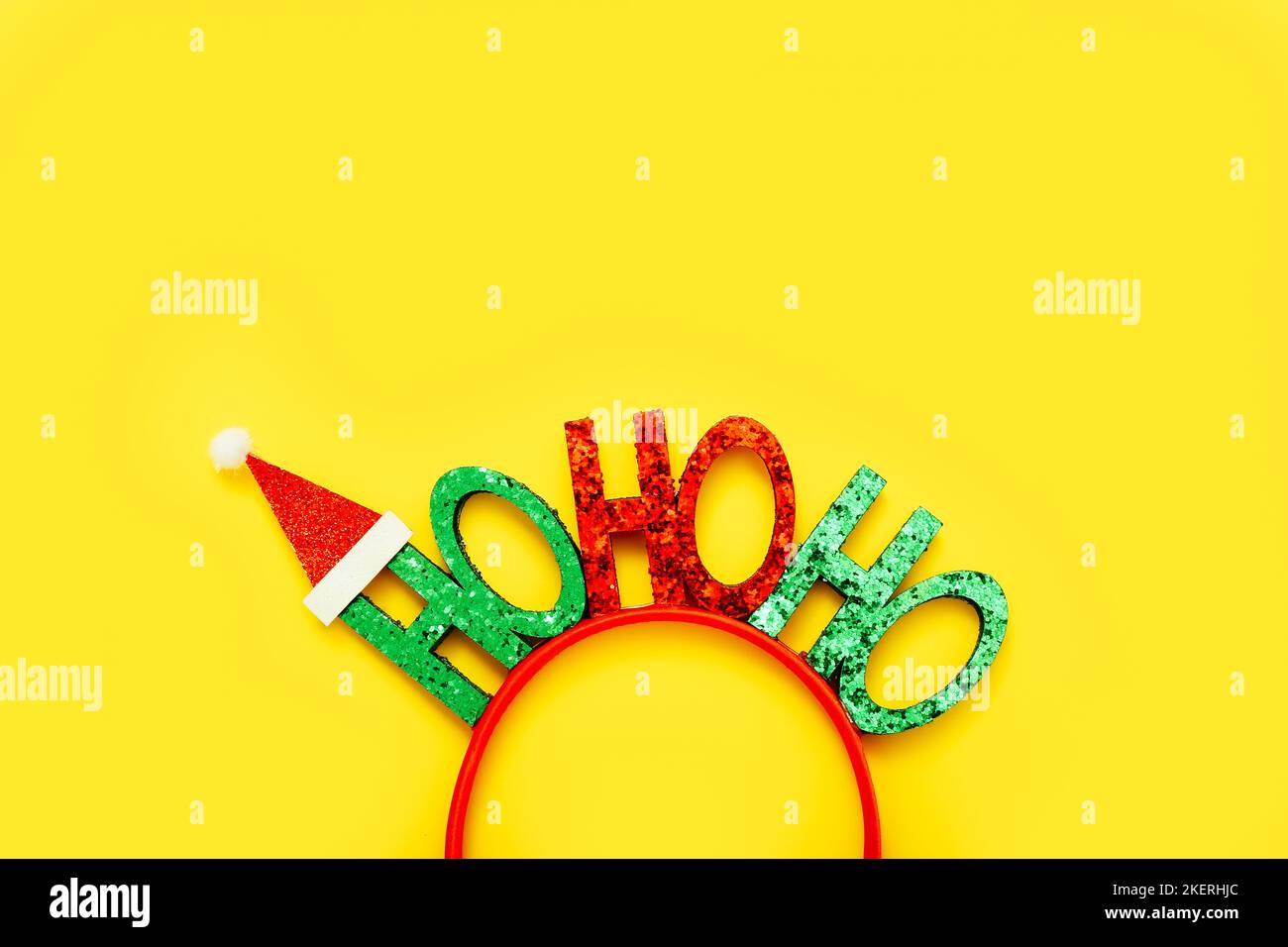 Christmas headband with letters HOHOHO on yellow background. Top view ...
