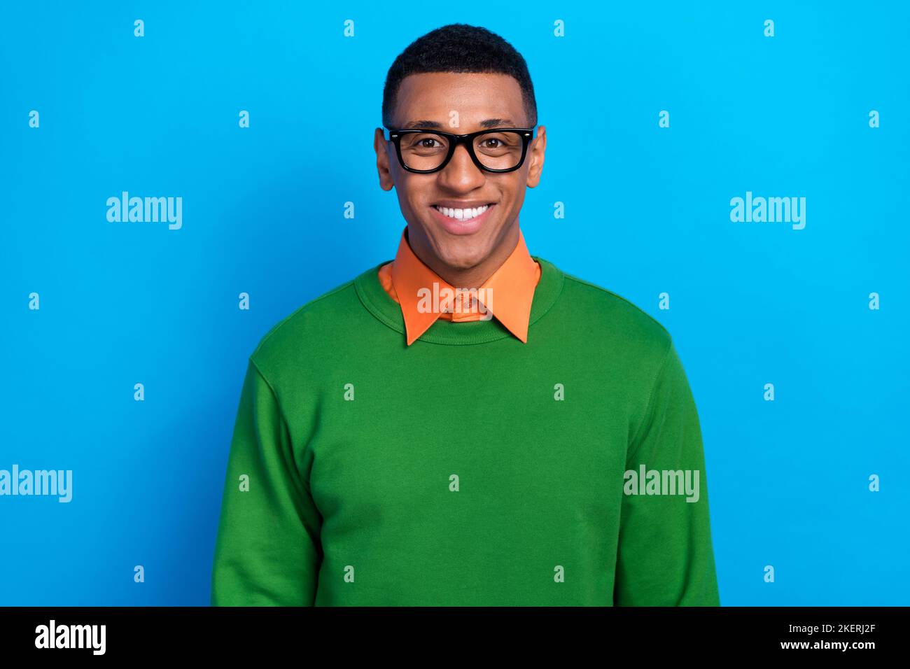 Photo of handsome positive satisfied man wear orange shirt under green ...