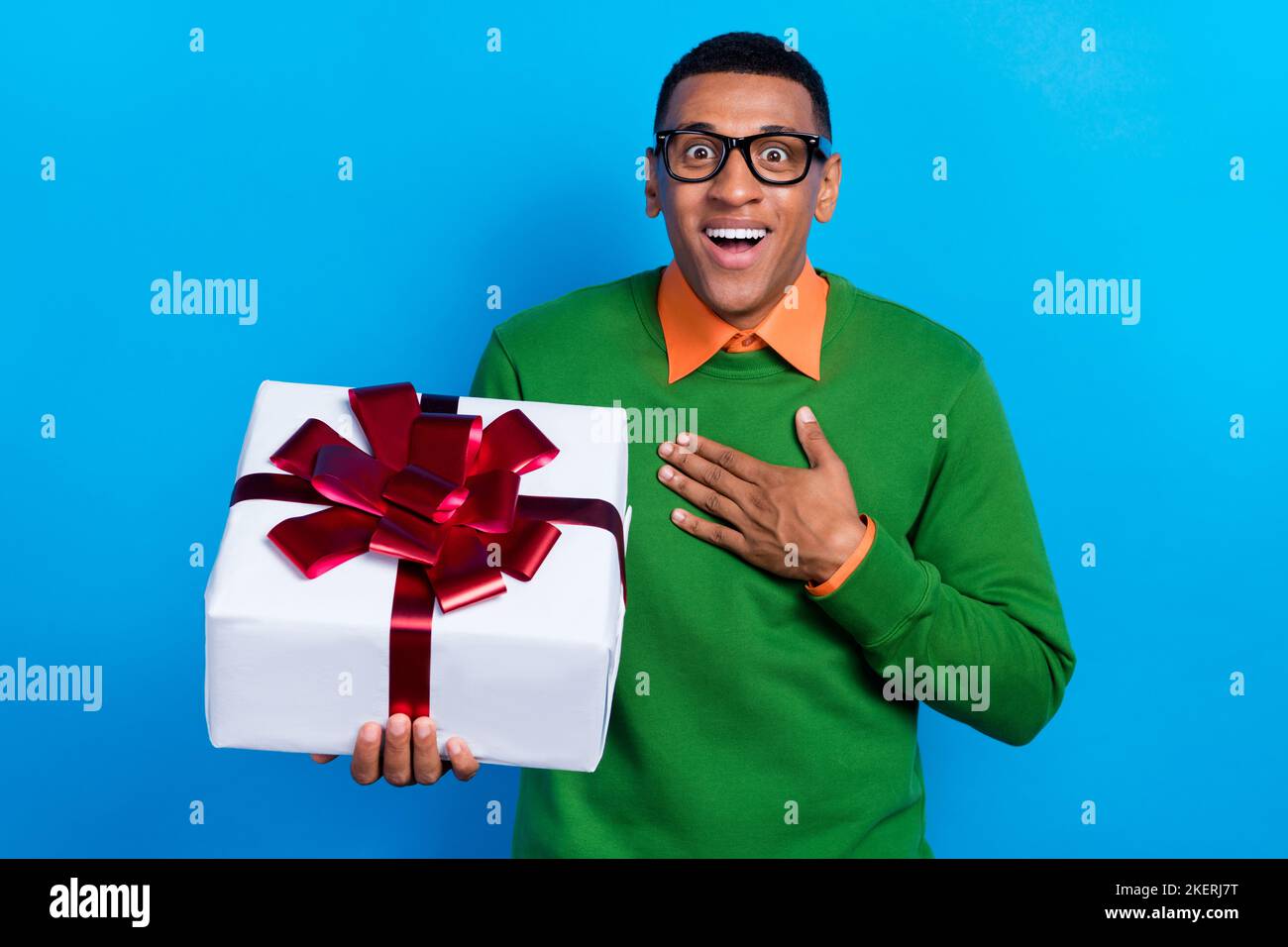 Photo of young cute gentleman wear green jumper touch chest hold big ...