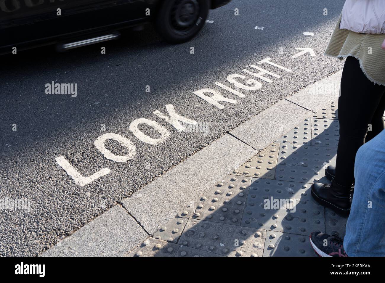Iconic 'look right' painted road marking for pedestrians in London with ...