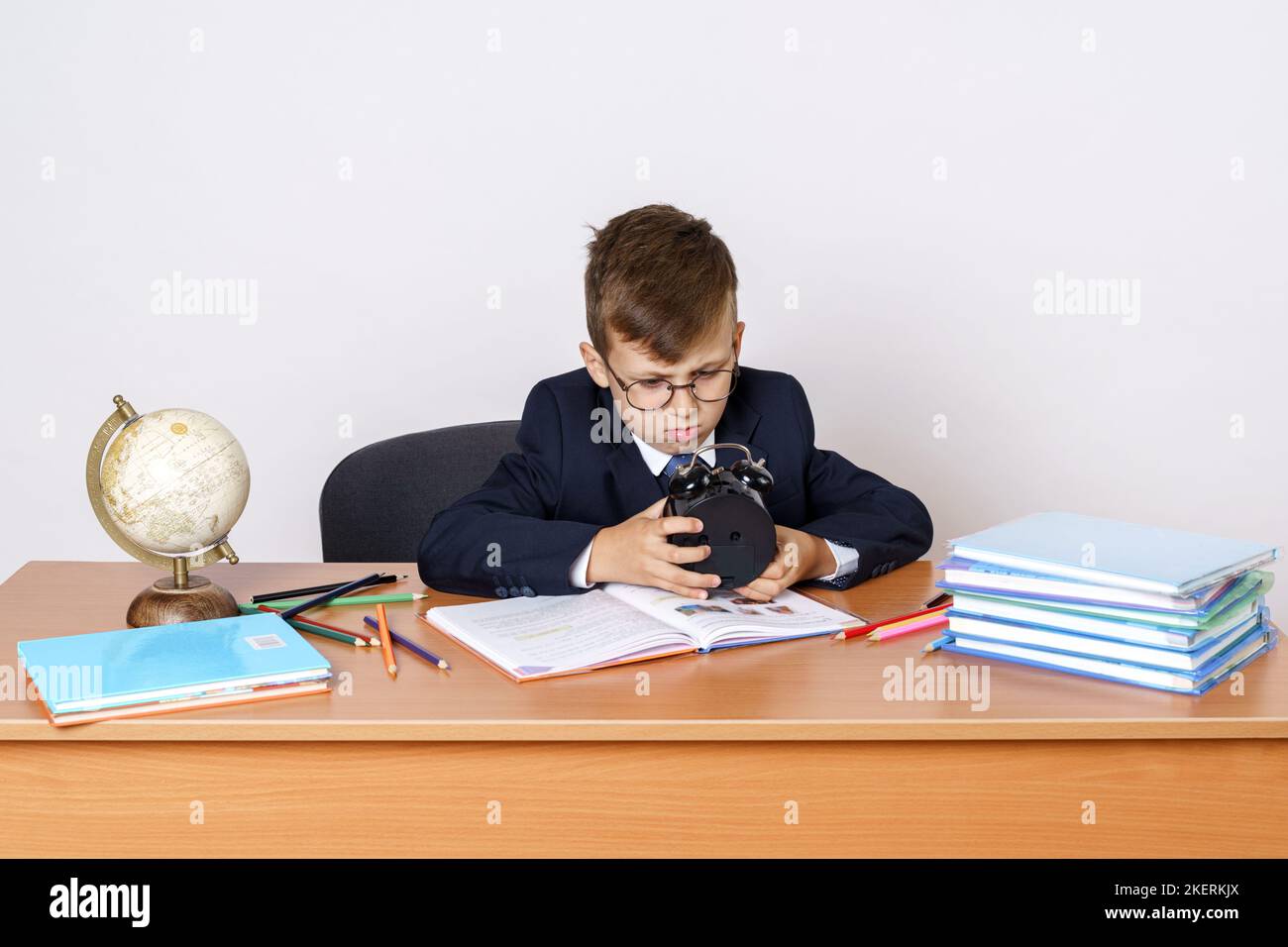 Education concept. The student sits at the table and writes. Books, a ...