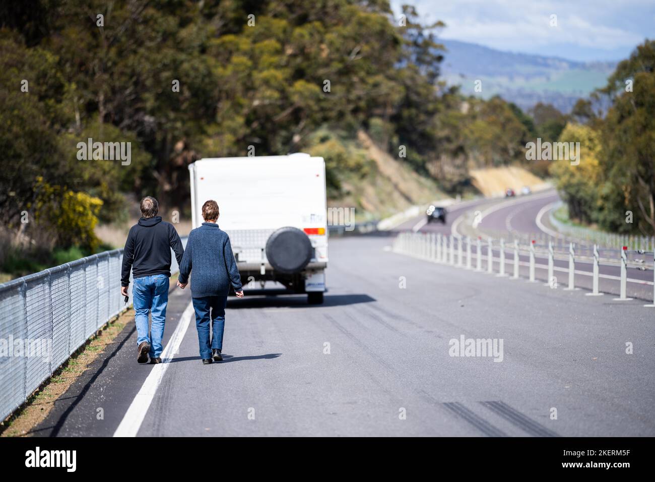 old couple travelling on a vaccation on a highway in america in spring ...