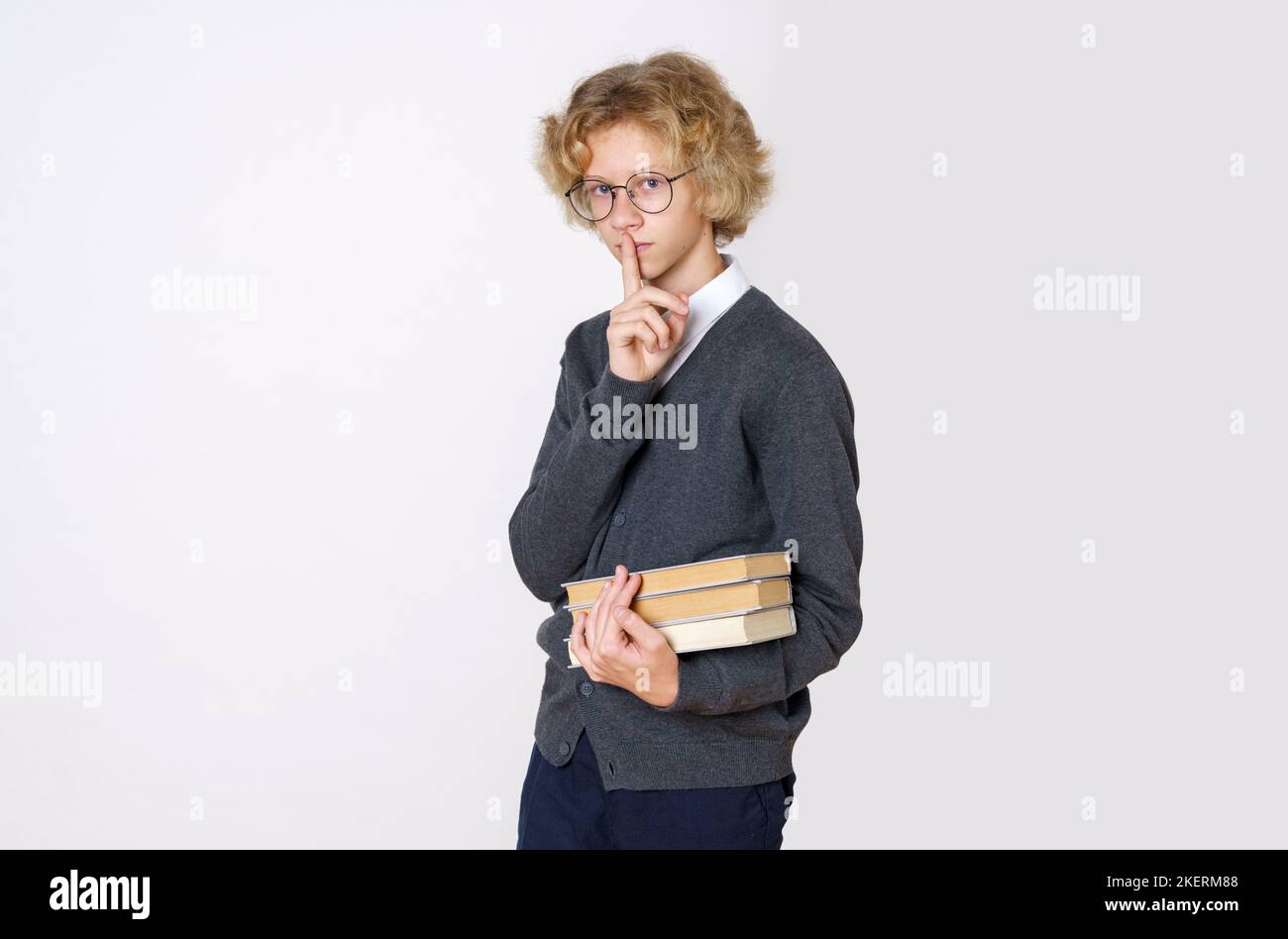Education concept. Portrait of a teenager boy who holds books in his ...
