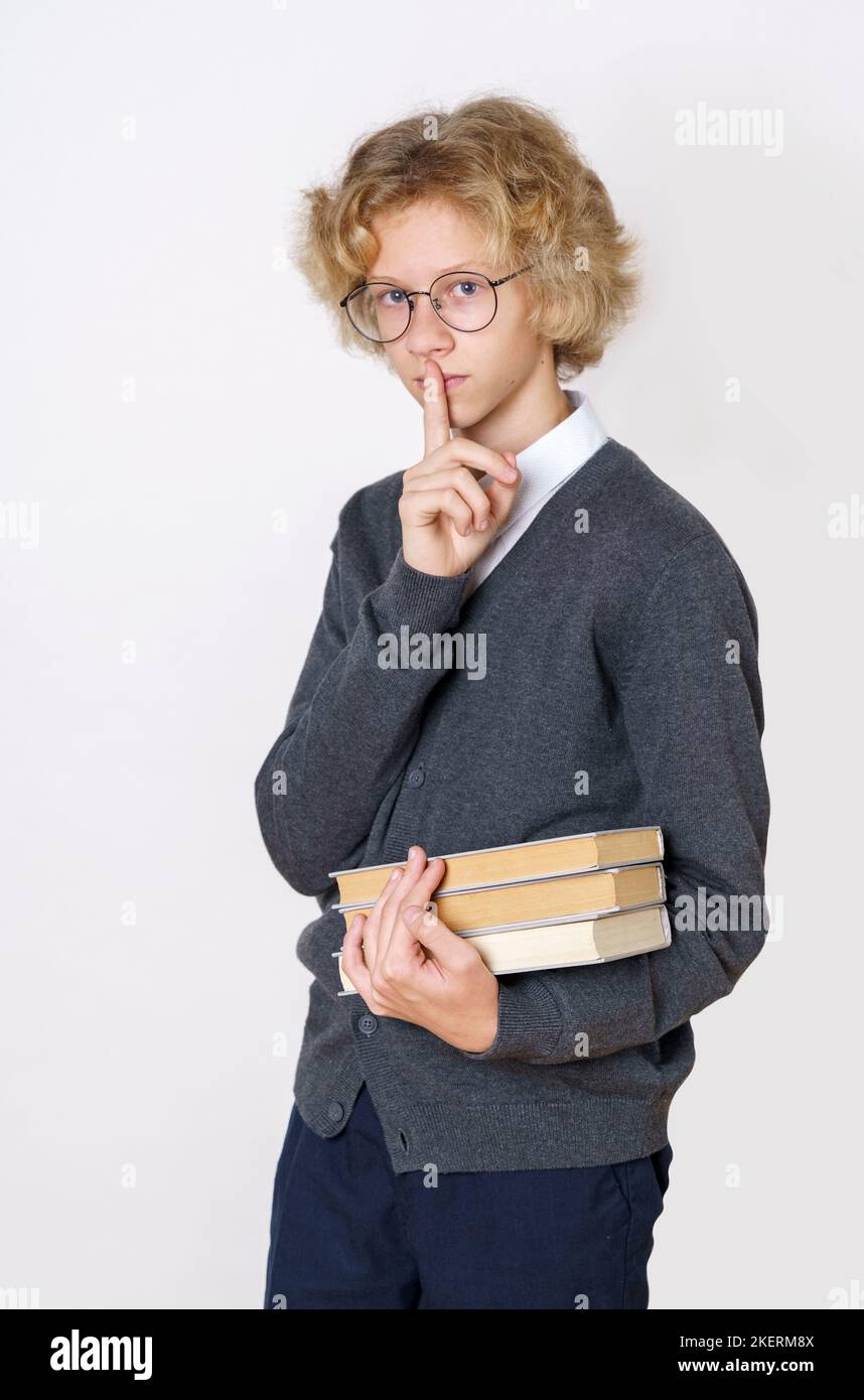 Education concept. Portrait of a teenager boy who holds books in his ...