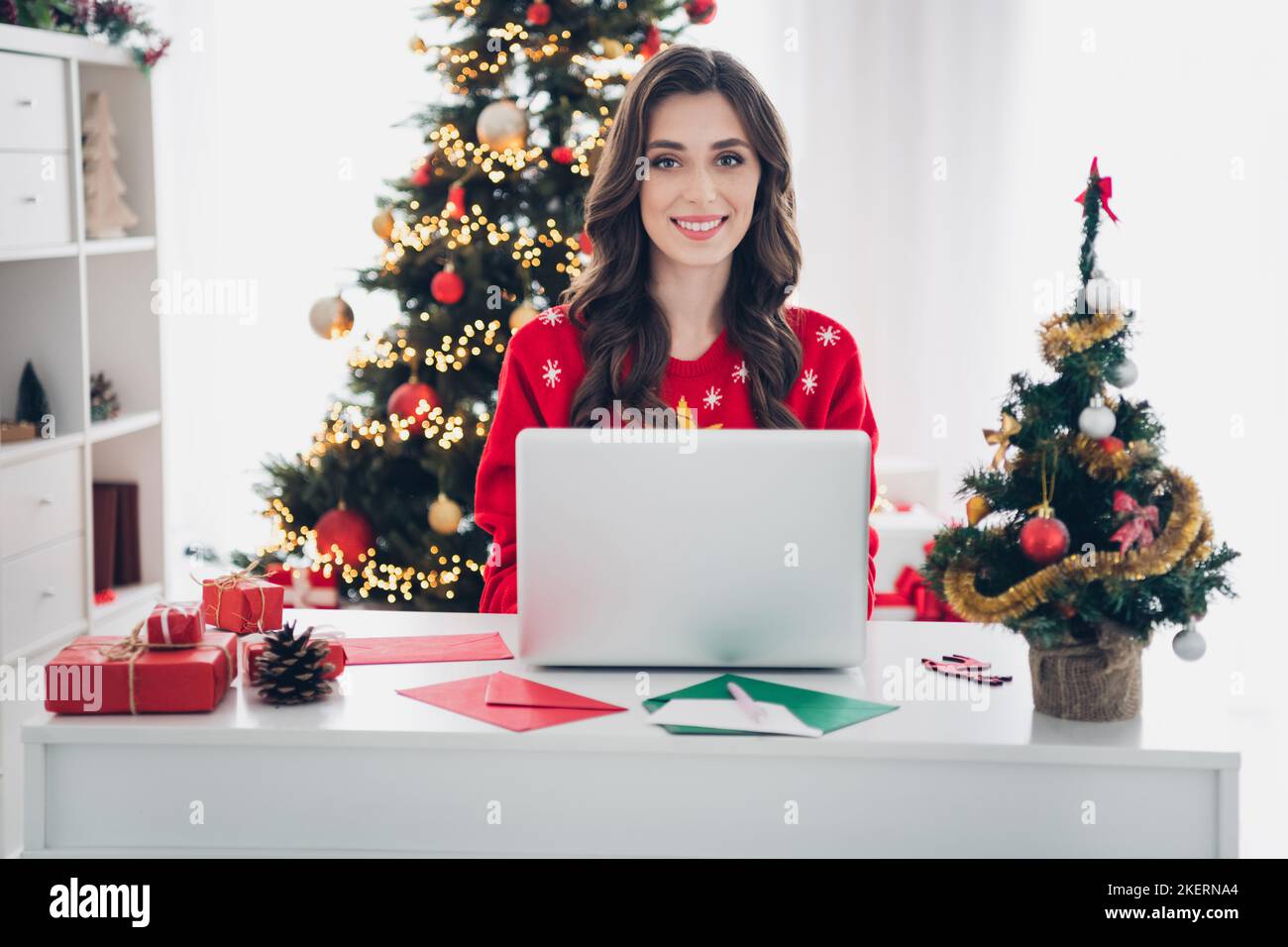 Photo of adorable pretty lady sitting workplace chatting clients online ...