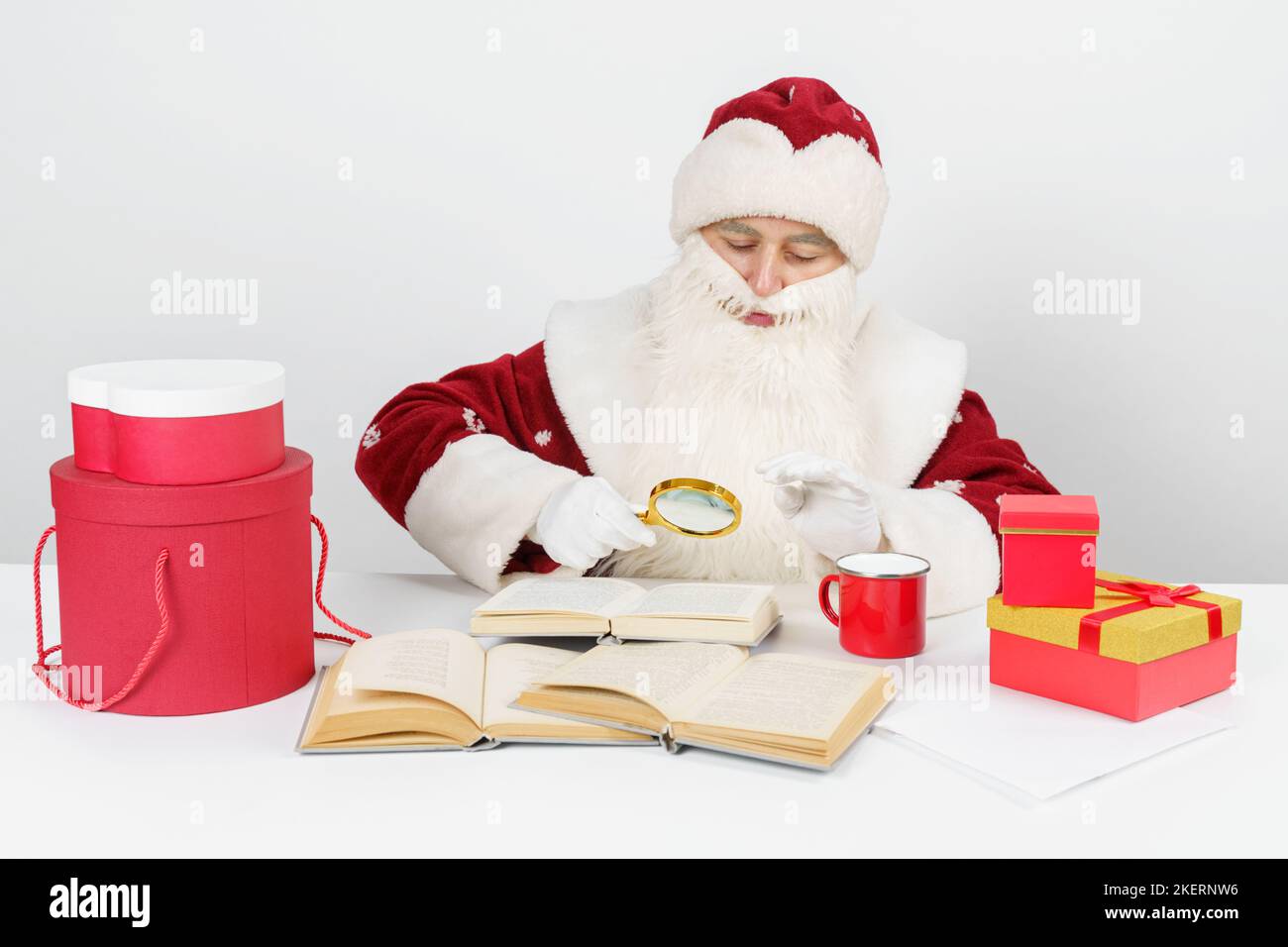 Christmas and New Years concept. A tired Santa Claus sits at a table ...