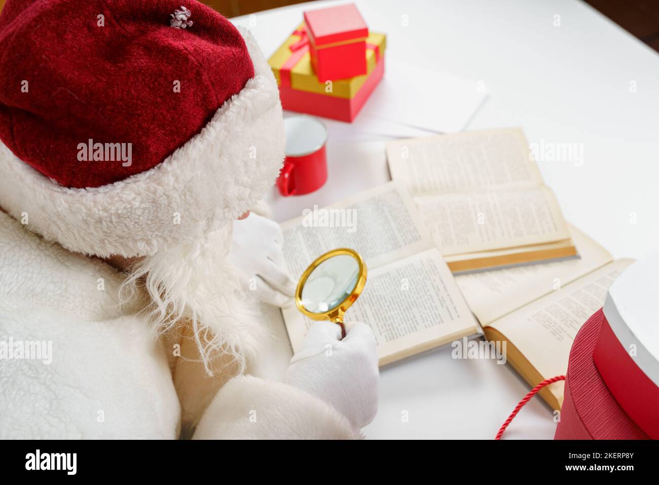 Christmas and New Years concept. A tired Santa Claus sits at a table ...