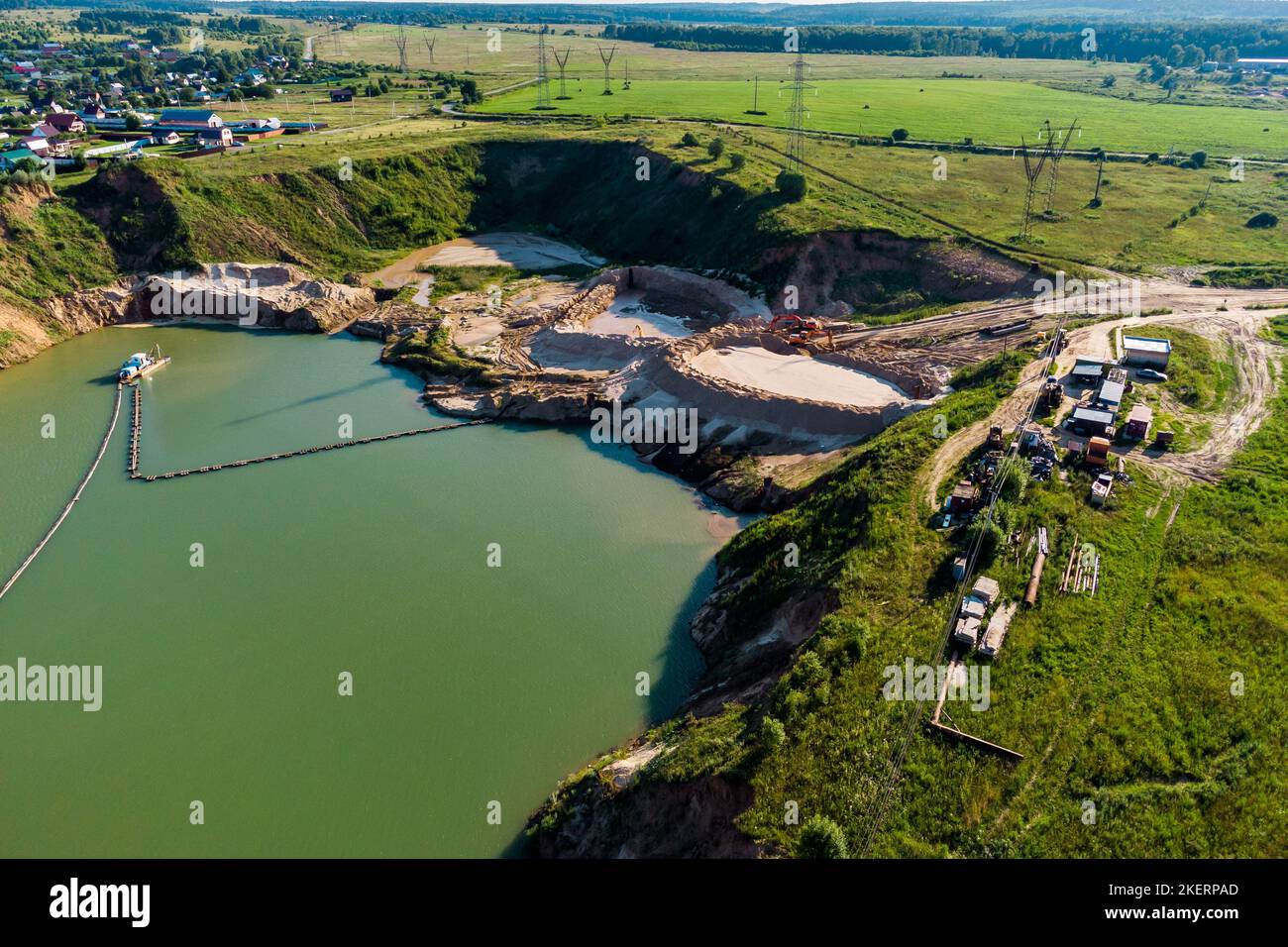 Sand mining in a flooded sand pit with a floating dredger, aerial view ...