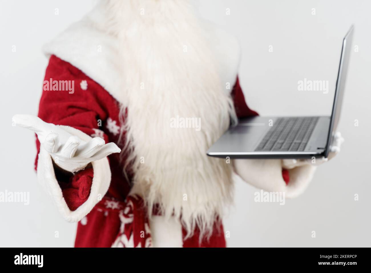 Christmas and New Year concept. Santa Claus sits at his desk and works ...