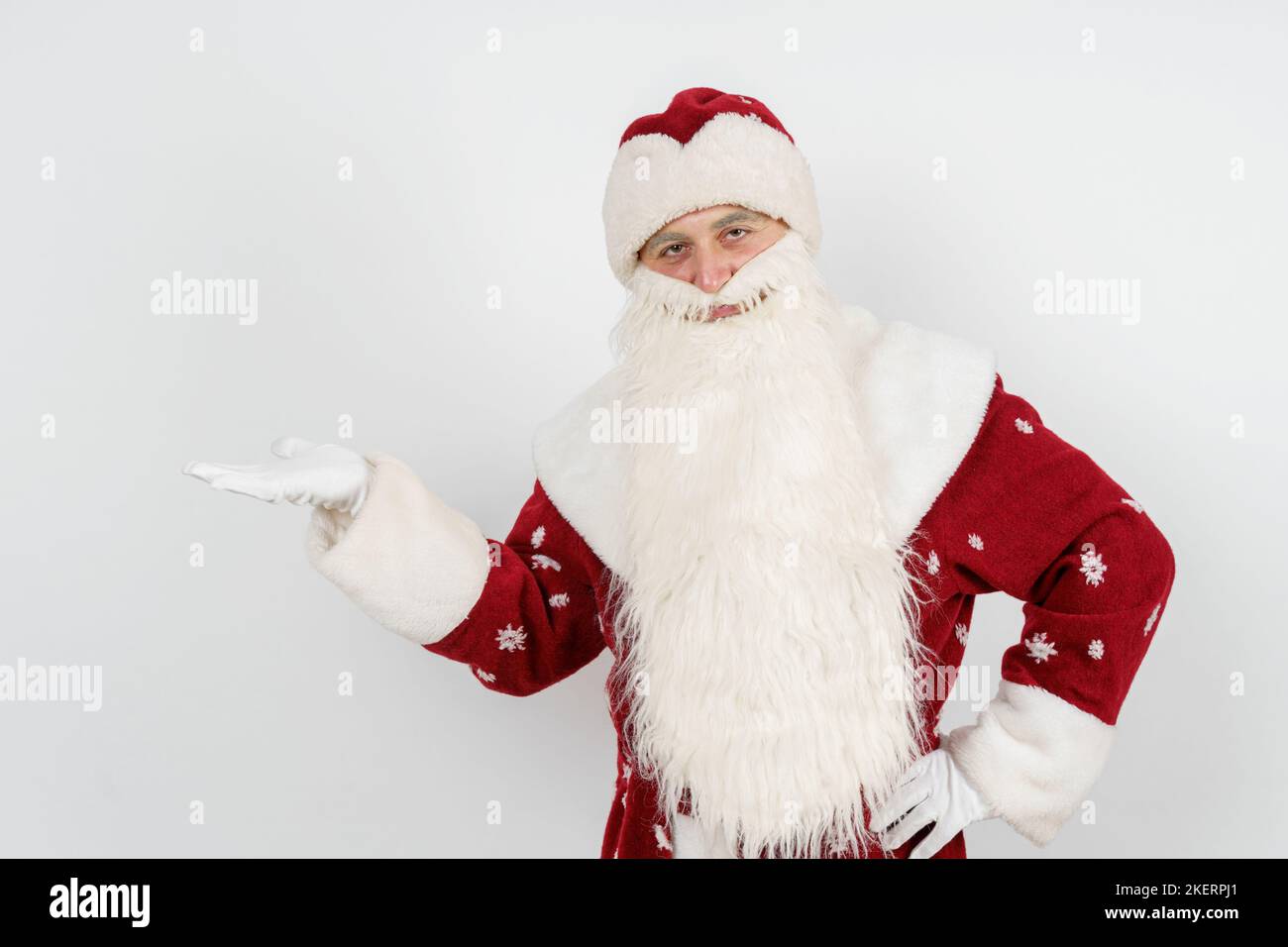 Christmas and New Years concept. Santa Claus shows a pointing gesture ...