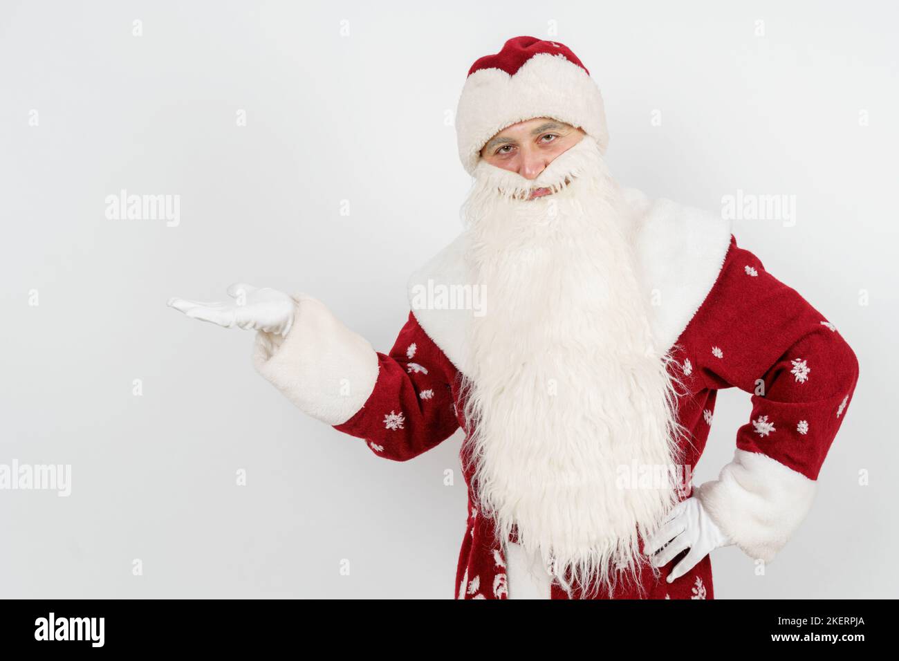 Christmas and New Years concept. Santa Claus shows a pointing gesture ...