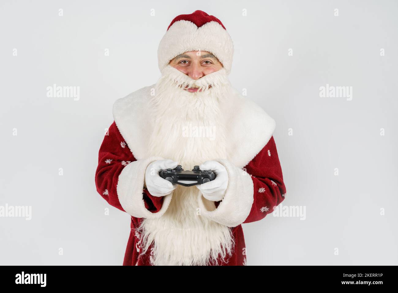 Holidays and Christmas concept. Santa Claus holds a joystick in his ...