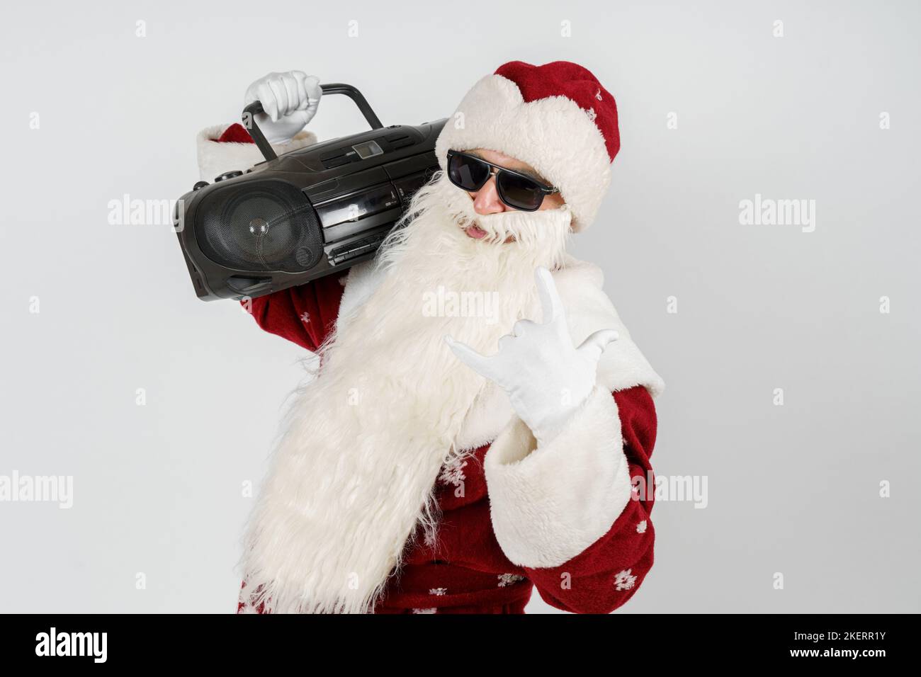Santa Claus is listening to a tape recorder. Isolated on white Stock ...