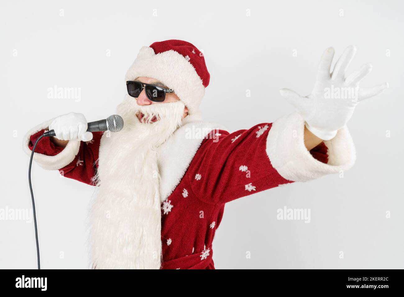 Holidays and christmas concept. Santa Claus sings with a microphone in ...