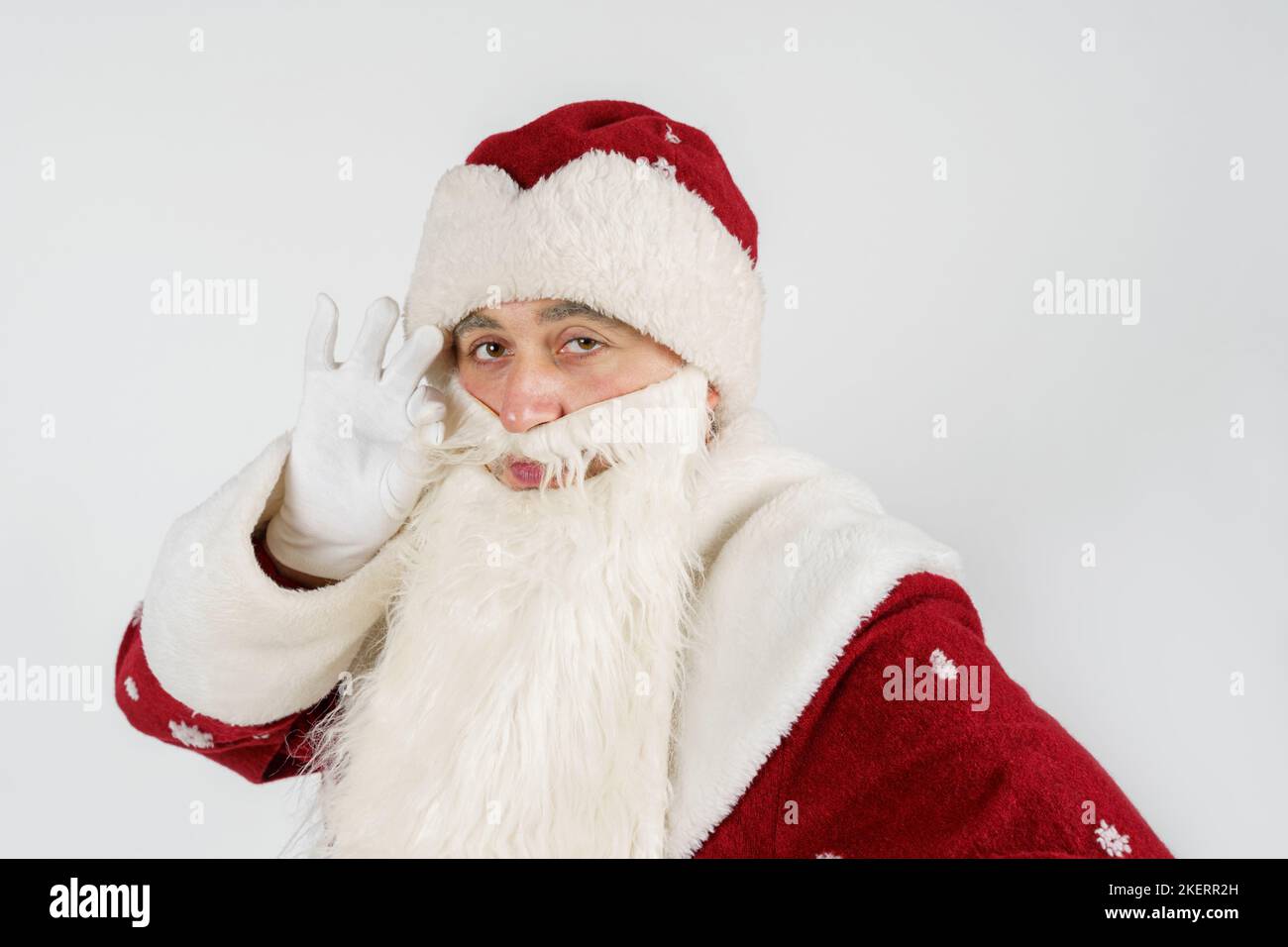 New year and villain concept. Santa Claus straightens his mustache with ...